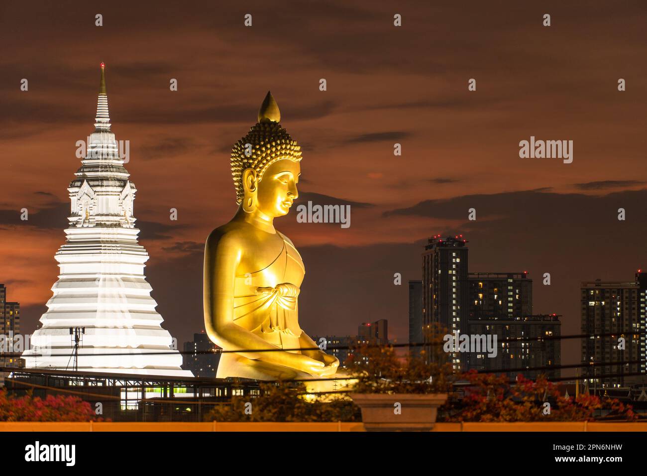 View of seated buddha in Wat Paknam Phasi Charoen temple at sunset ...