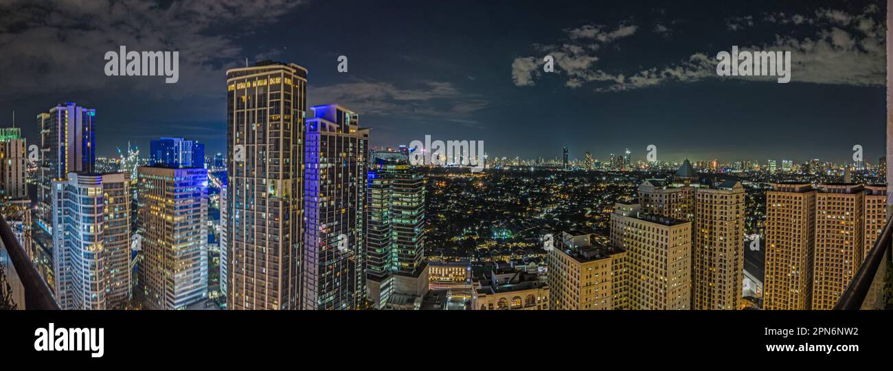 Panoramic image over Manila skyline at night in moonlight Stock Photo ...