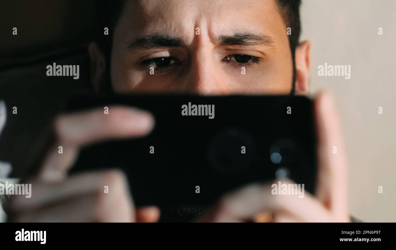 Phone movie gadget fatigue disturbed man face eyes Stock Photo - Alamy