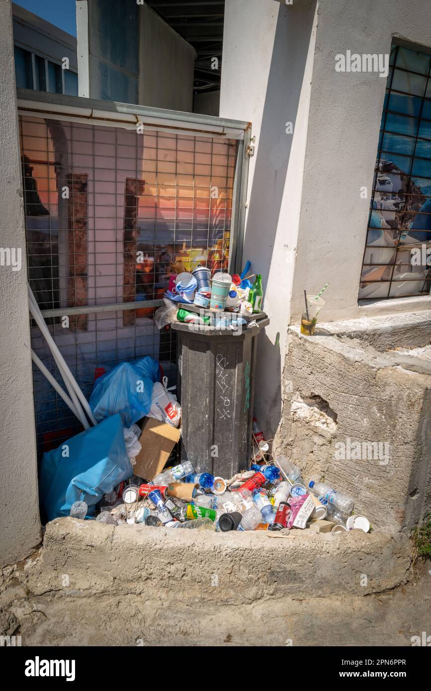 a garbage can is overflowing with garbage Stock Photo - Alamy