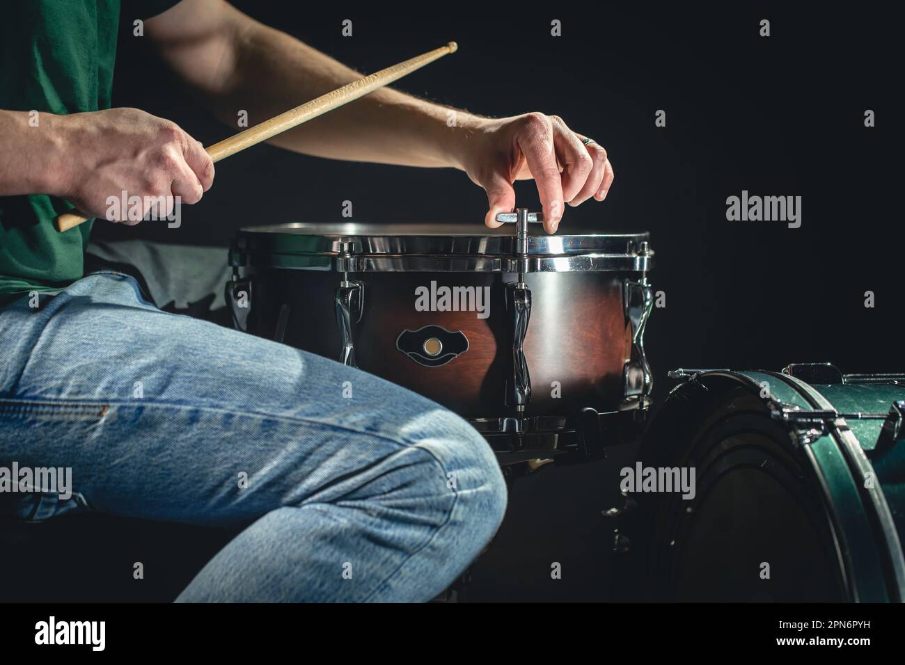 A man plays the snare drum against a dark background Stock Photo - Alamy