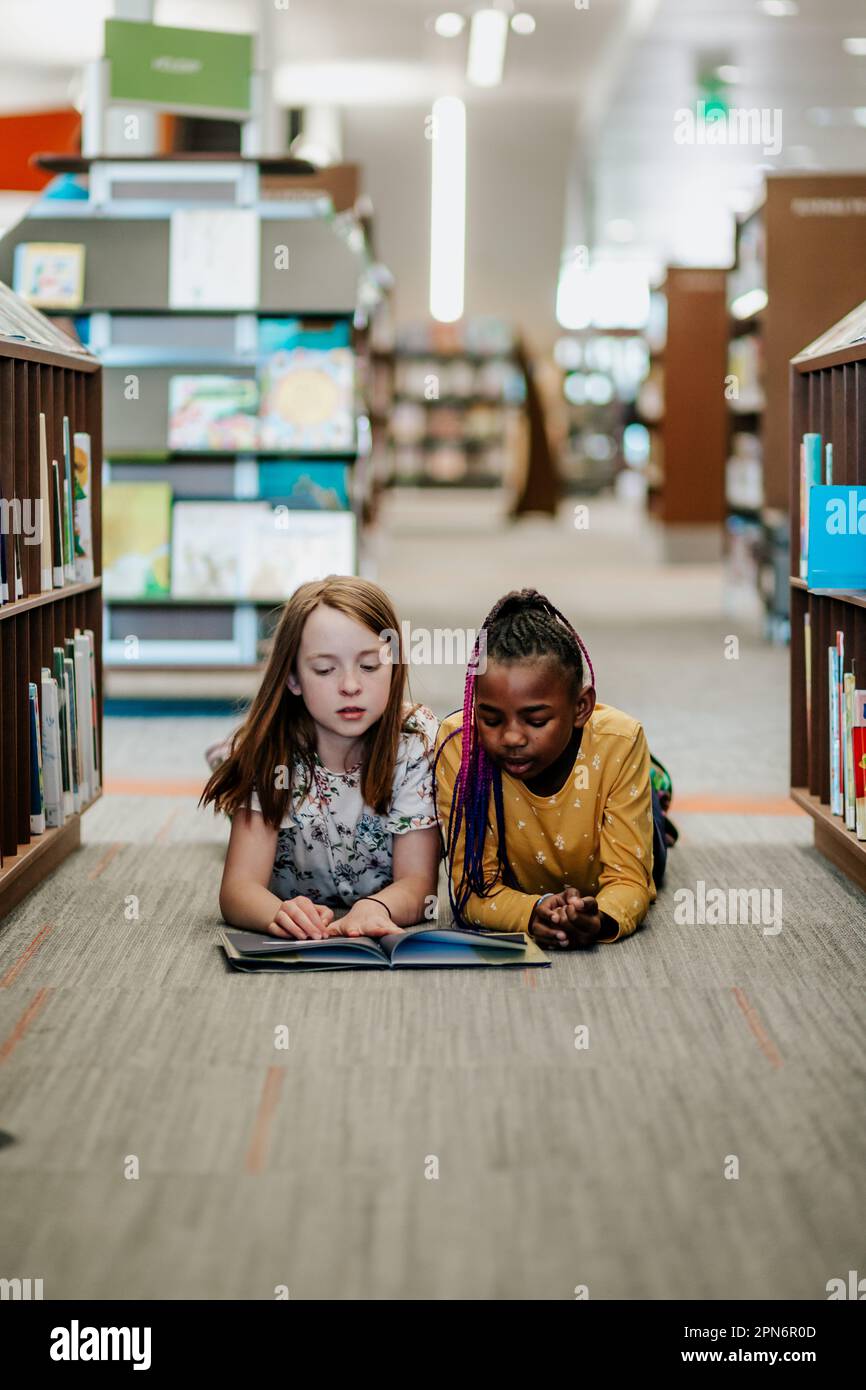 Two girls reading book hi-res stock photography and images - Alamy