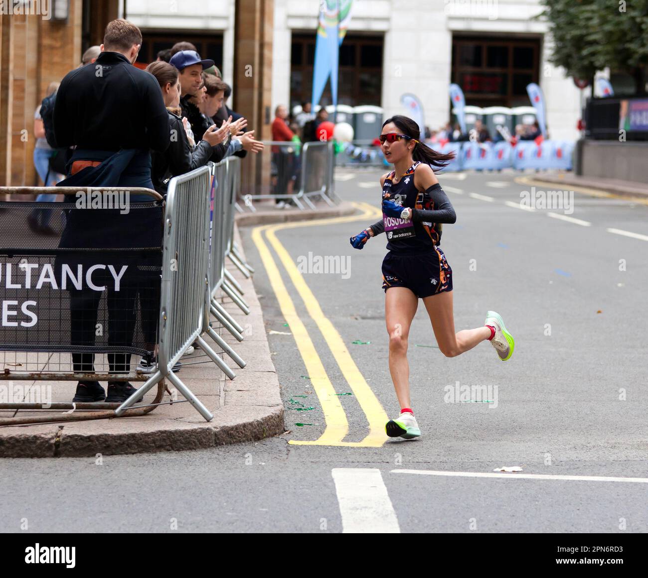 Ai Hosoda from Japan, passing through Cabot Square, on her way to ...