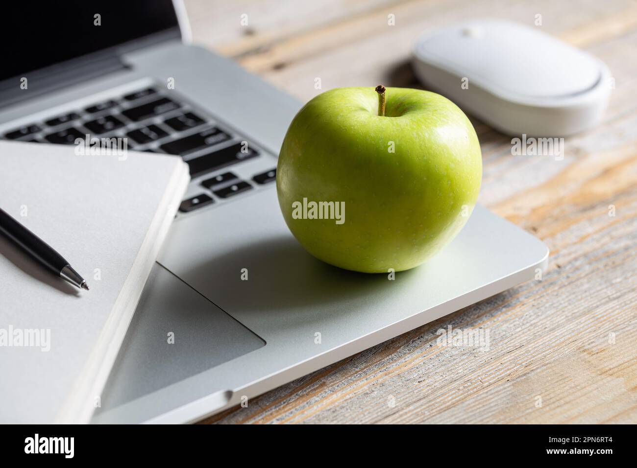 Apple near laptop at workplace, healthy snack Stock Photo - Alamy
