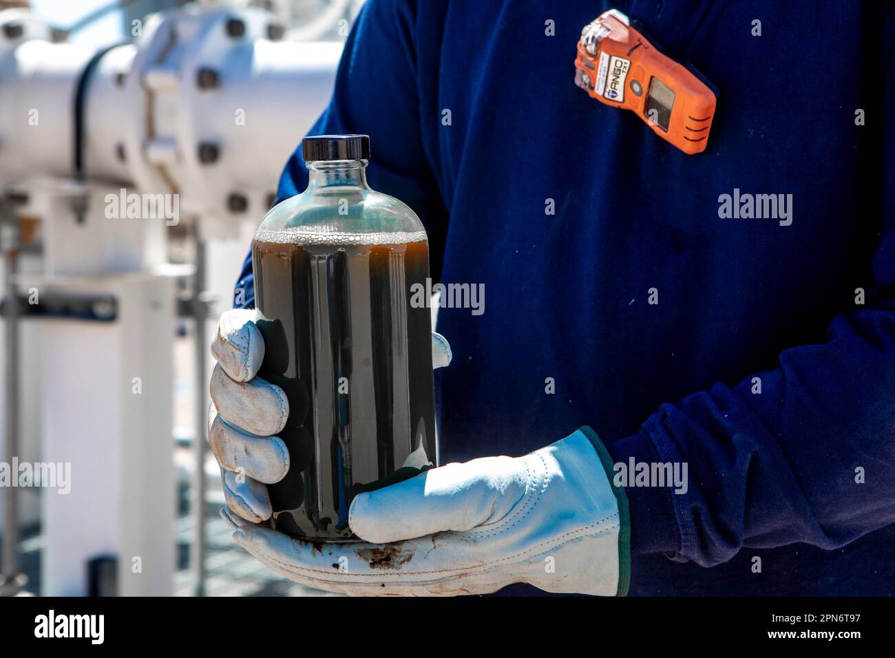 Pulling oil samples in tank farm Stock Photo - Alamy
