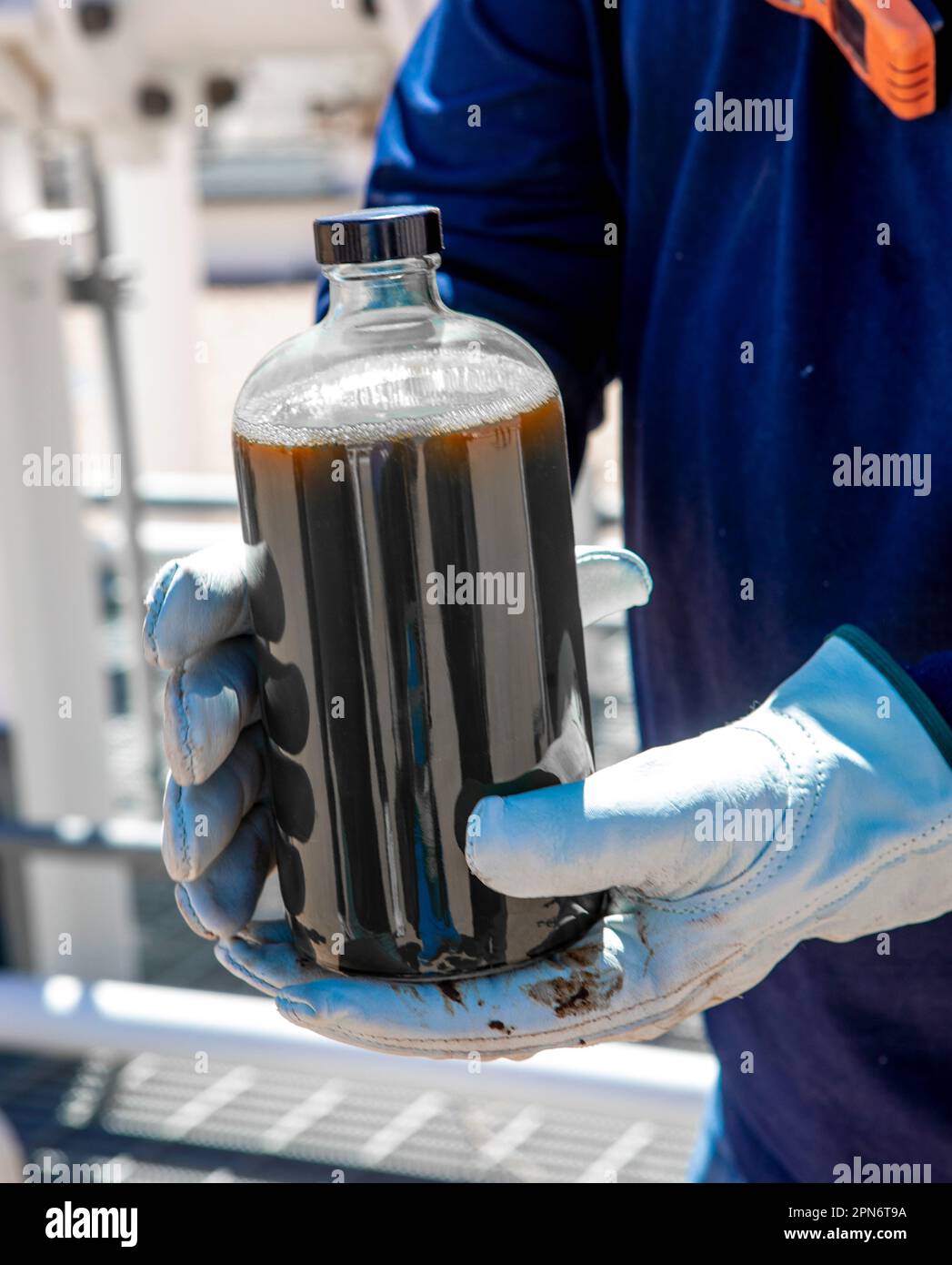 Pulling oil samples in tank farm Stock Photo - Alamy