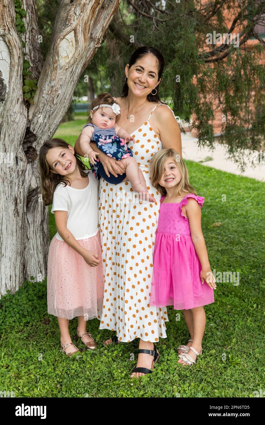 Portrait of mom with young happy daughters Stock Photo - Alamy