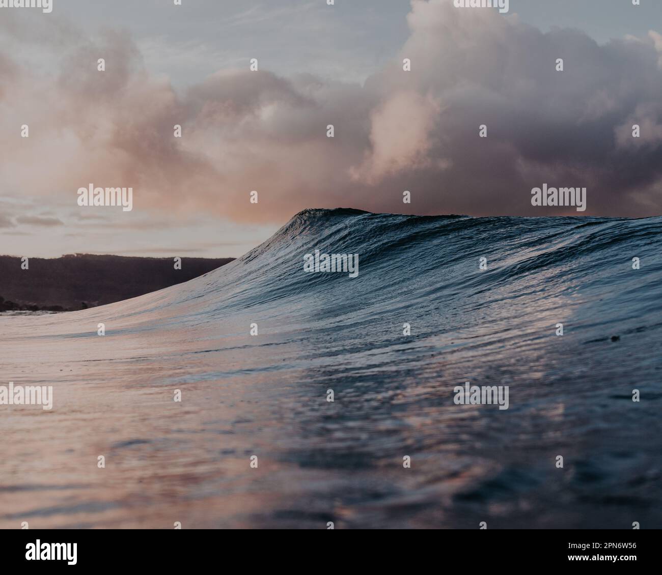 Chasing moments in the ocean at sunset Stock Photo - Alamy