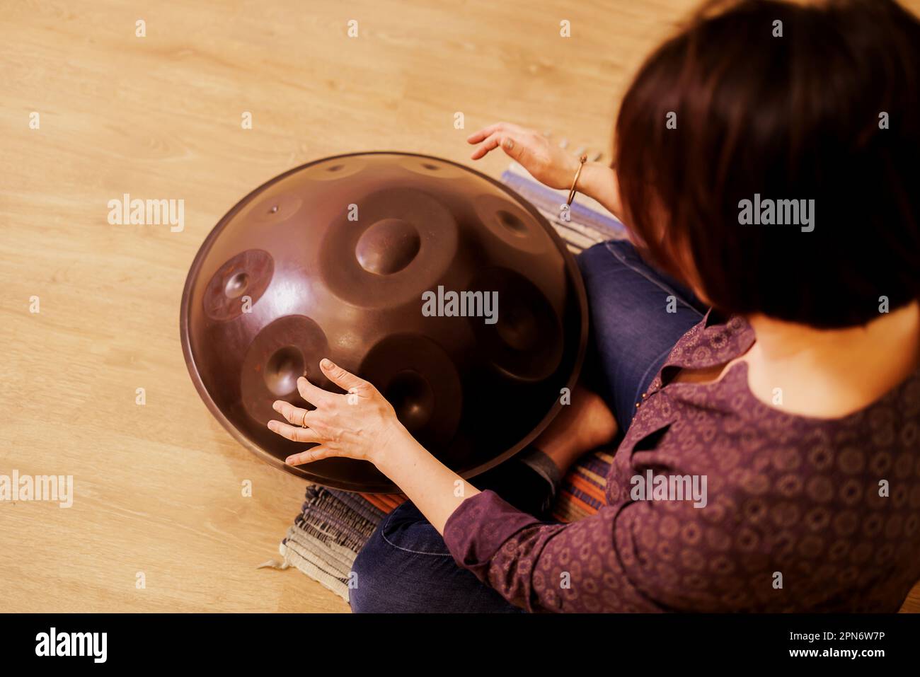 rear view, hands on an unusual musical instrument Stock Photo - Alamy