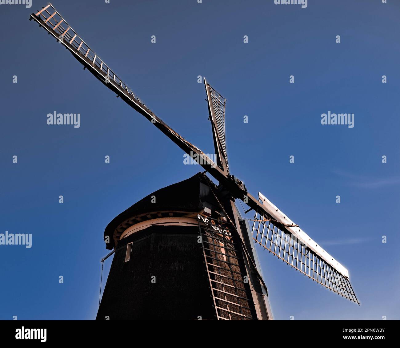 View of dutch mill under the sun rays Stock Photo - Alamy