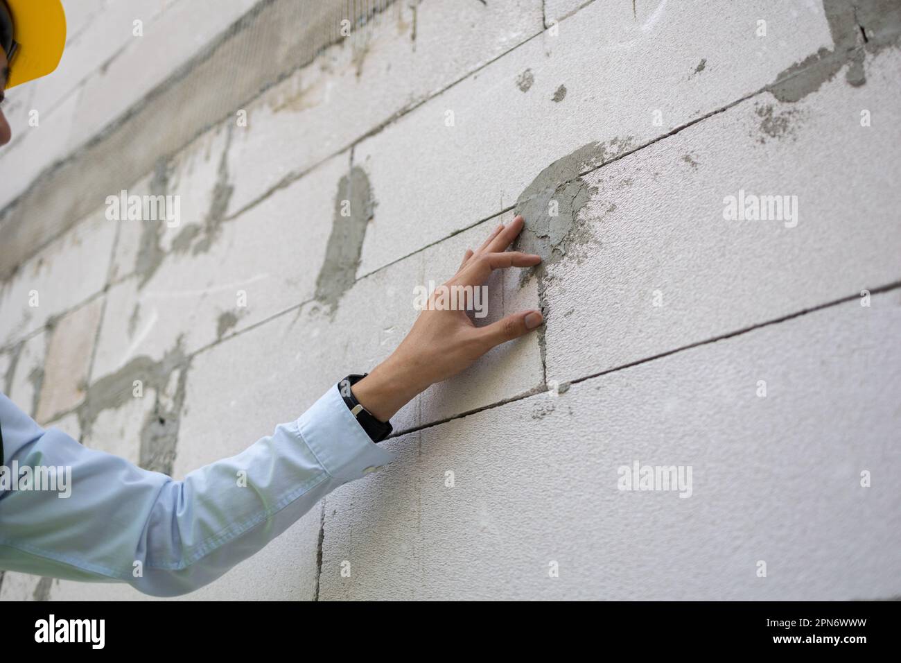 Asian engineer in uniform at construction site while checking and ...