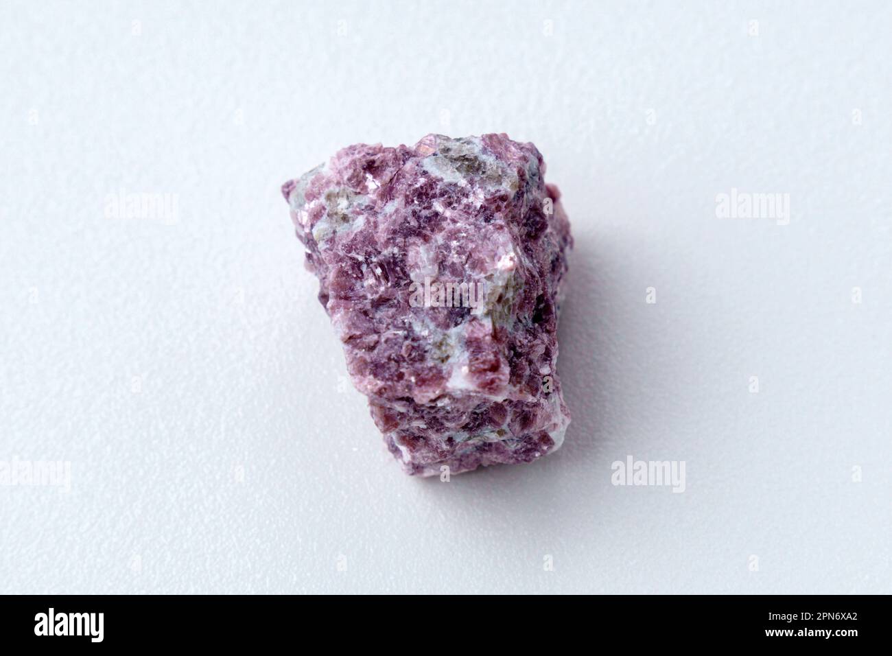 Lepidolite stone on a white background, being a secondary source of ...