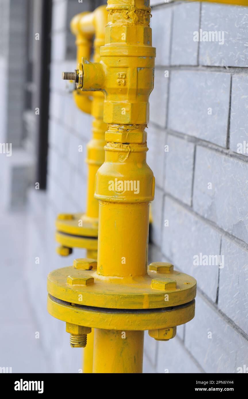 Pipe and yellow valve Stock Photo - Alamy