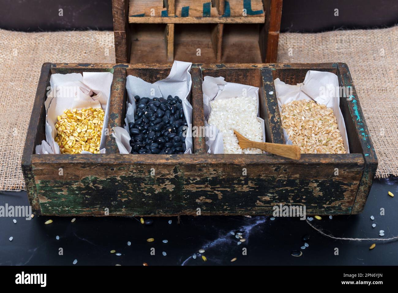 A batea with white yamani rice, brown yamani rice, black beans and mote ...