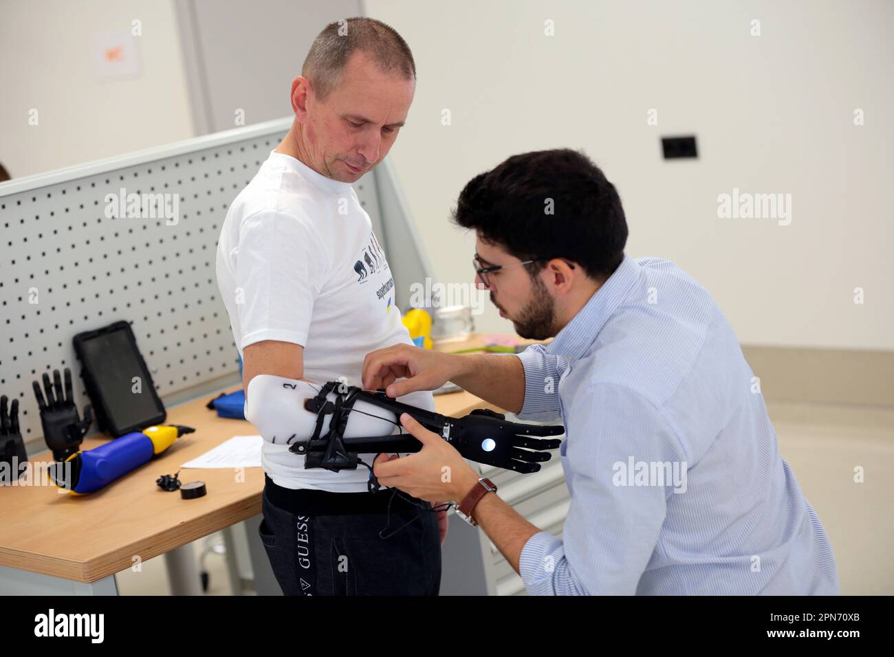 LVIV, UKRAINE - APRIL 14, 2023 - A doctor fits a prosthetic arm on one ...