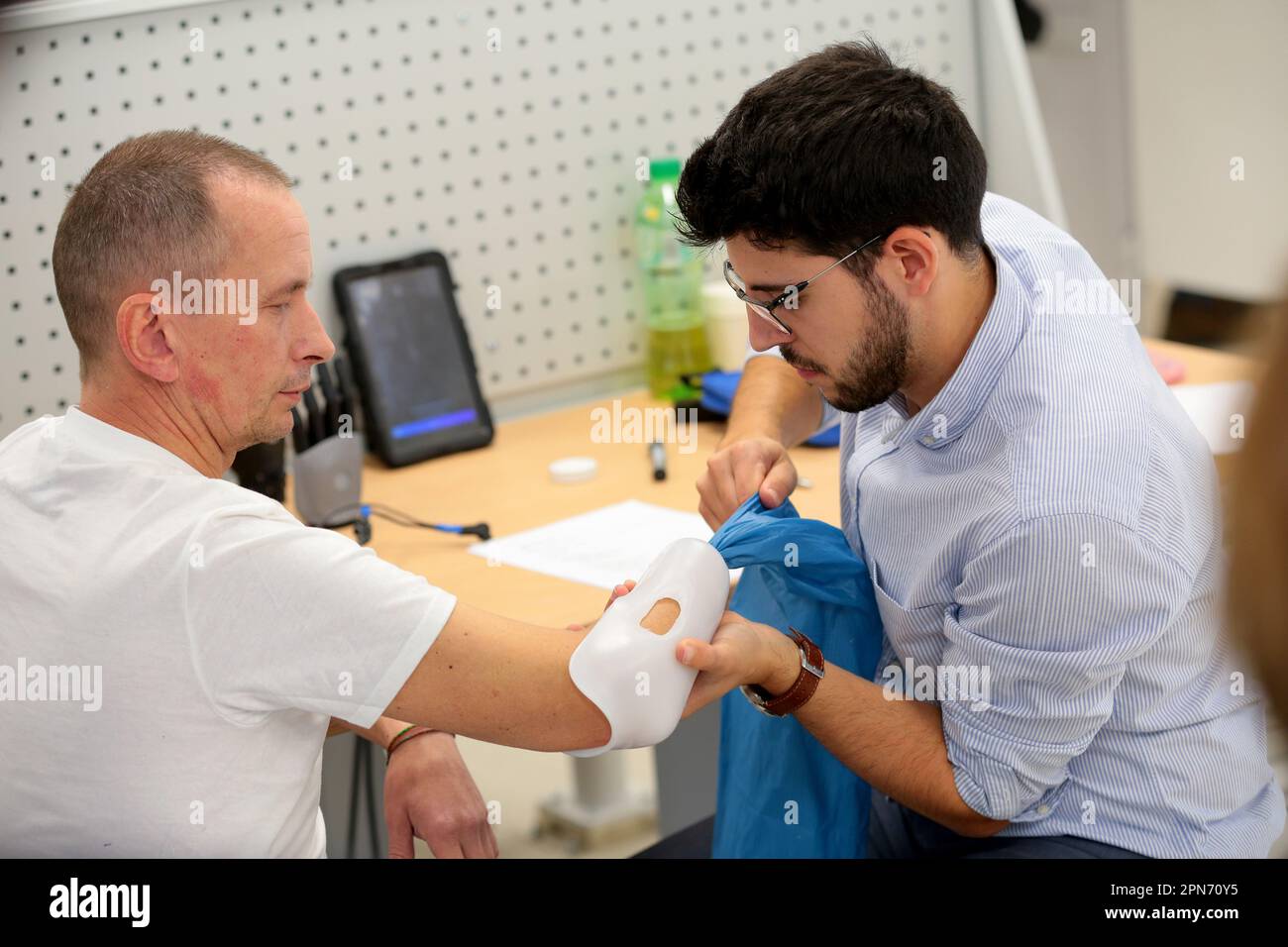 LVIV, UKRAINE - APRIL 14, 2023 - A doctor fits a prosthetic arm on one ...