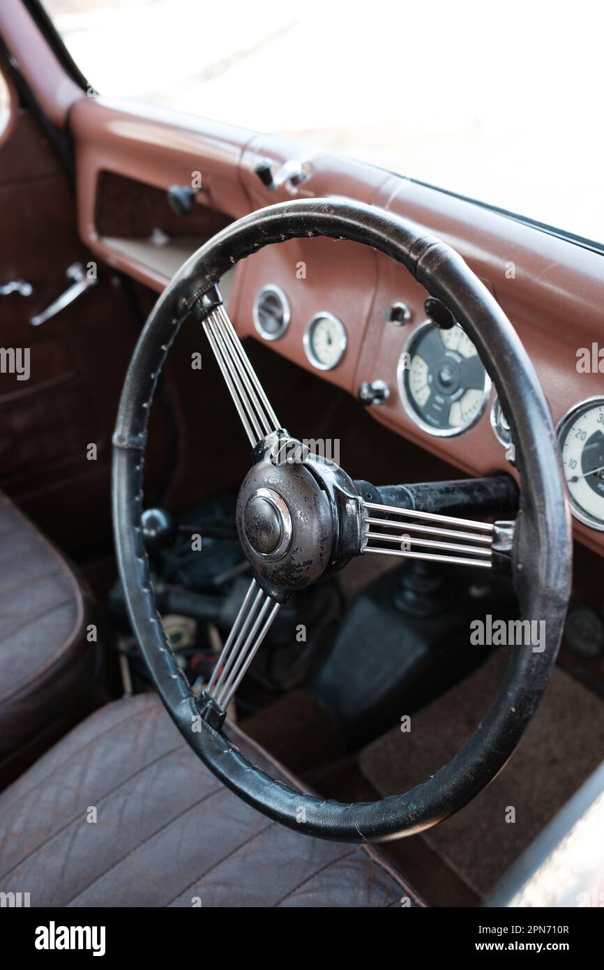 A classic car with its old steering wheel, control panel, and dashboard ...