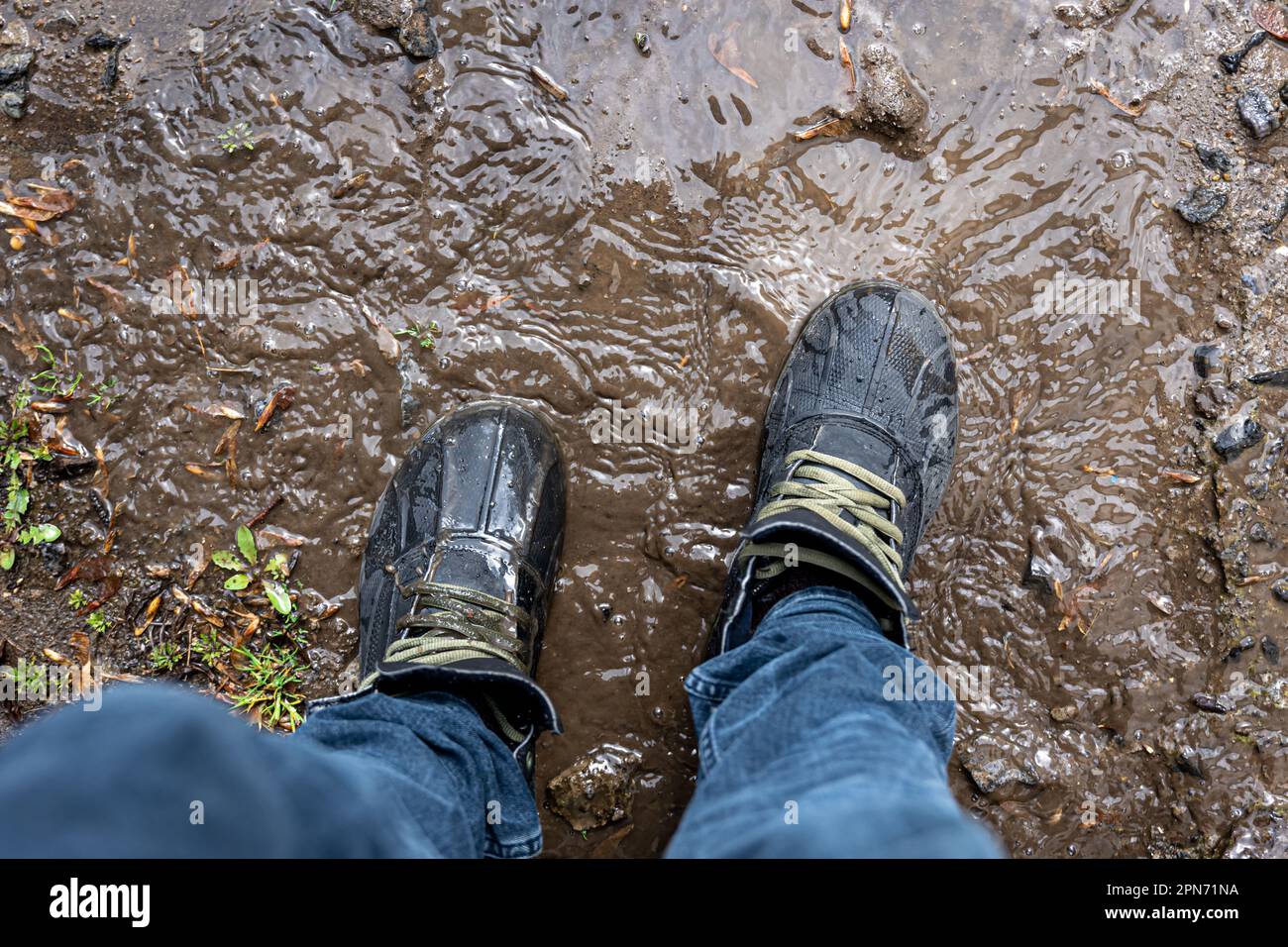View from above on pair of trekking shoes in a mud Stock Photo - Alamy