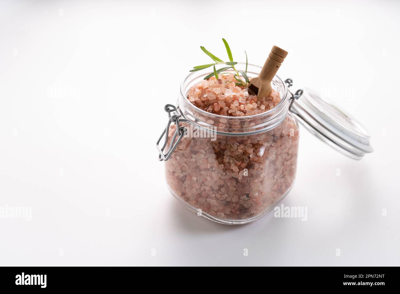 Himalayan pink salt on glass of jar isolated on white background with ...
