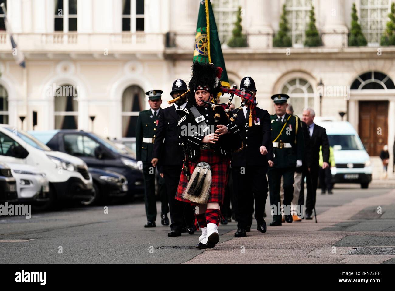 A piper leads The London Ambulance Ceremonial Unit to the memorial ...
