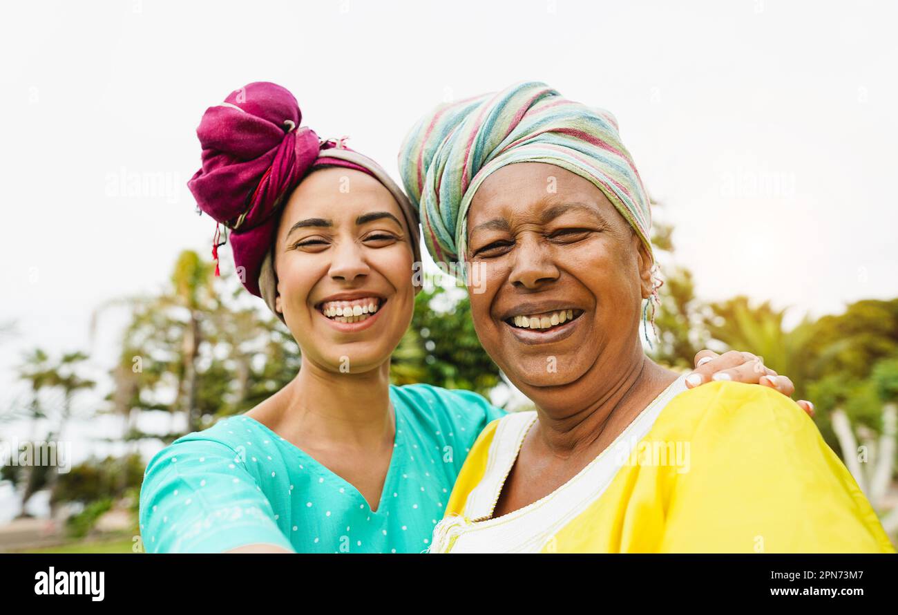 Happy african mother and daughter wearing traditional clothes while ...