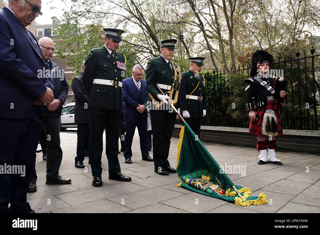 The London Ambulance Ceremonial Unit flagbearer lowers a flag during ...