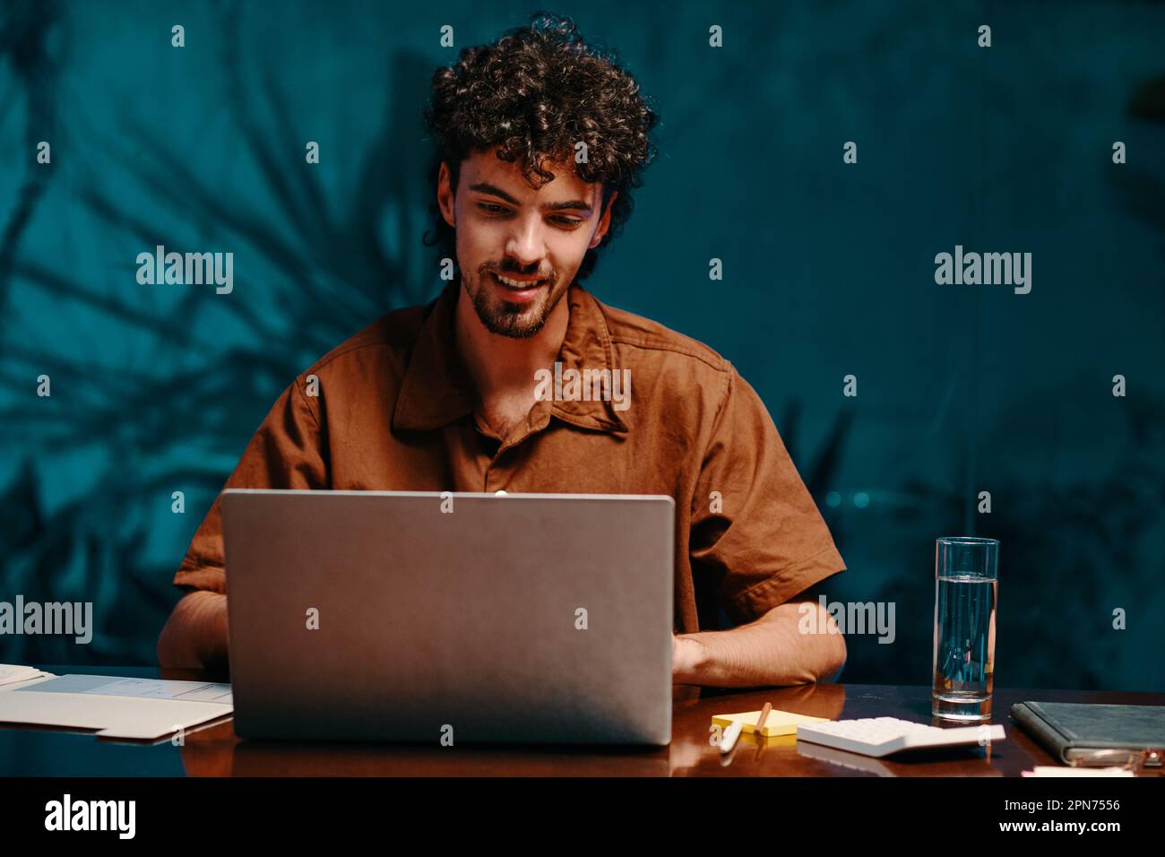 Portrait of positive software developer working on laptop Stock Photo ...