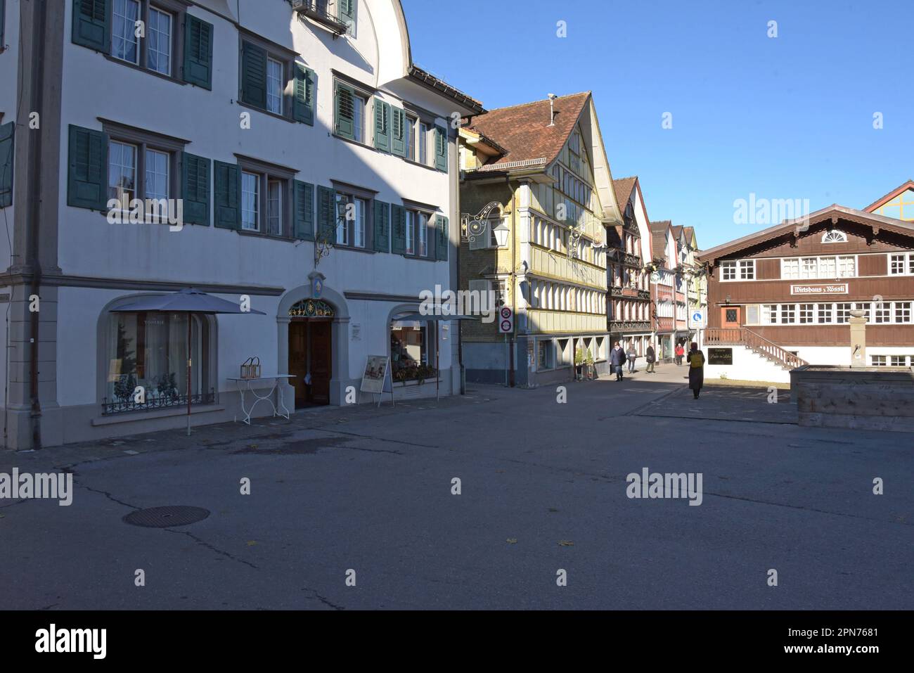 People shopping and walking around the car-free pretty traditional ...