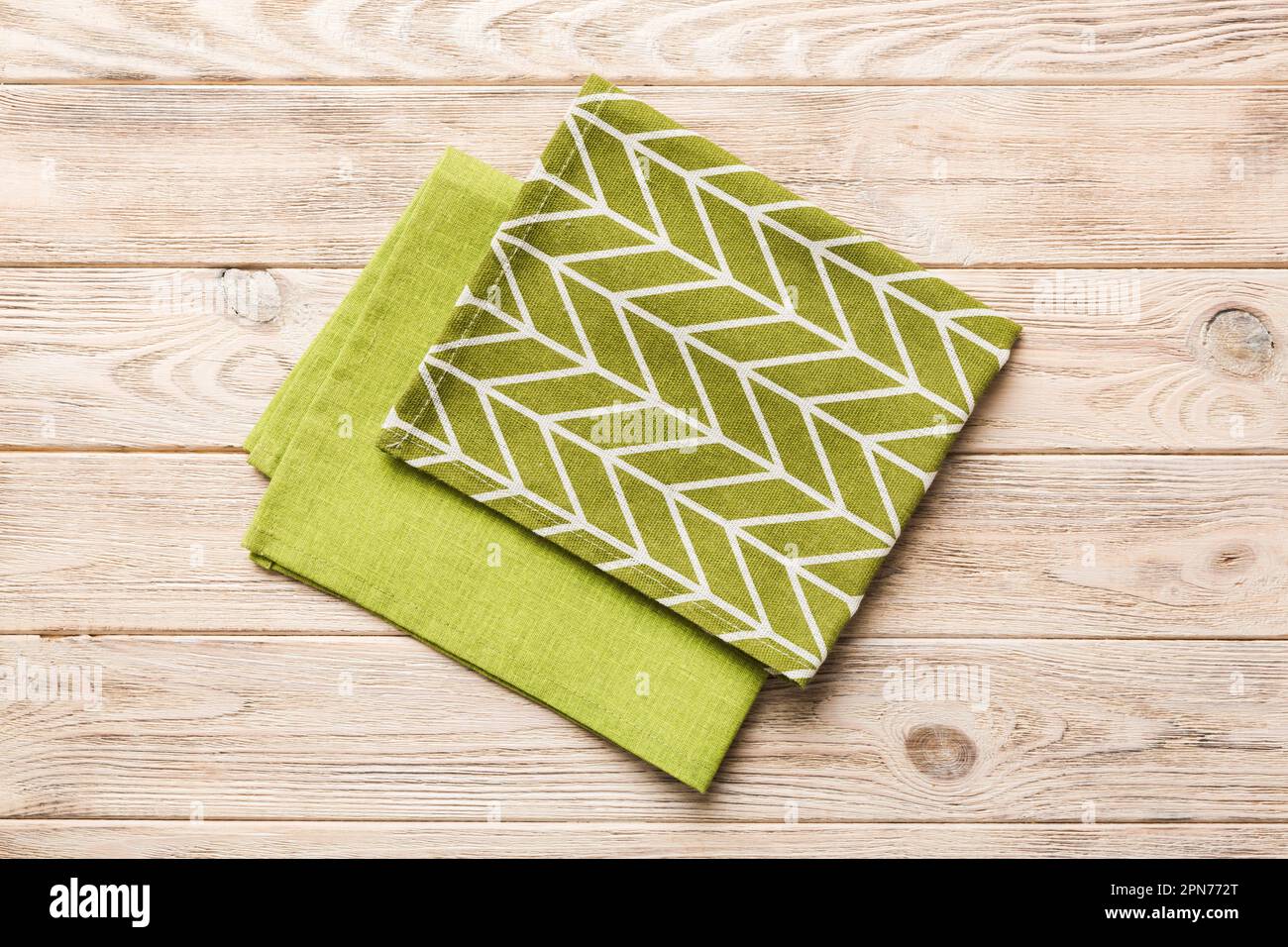 top view with green kitchen napkin isolated on table background. Folded ...