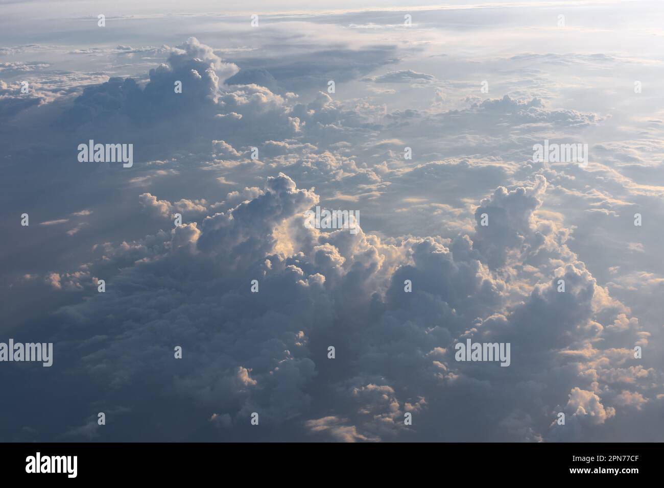 Clouds view from the plane. Blue cumulus clouds in bright sunlight ...