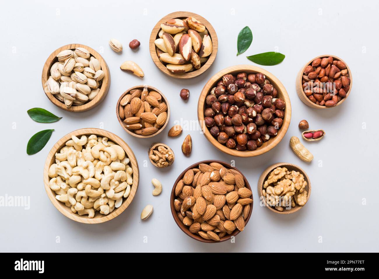 mixed nuts in wooden bowl. Mix of various nuts on colored background ...