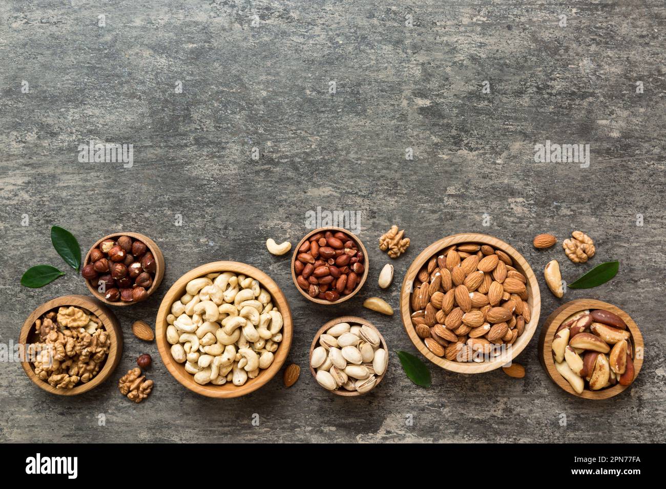 mixed nuts in wooden bowl. Mix of various nuts on colored background ...