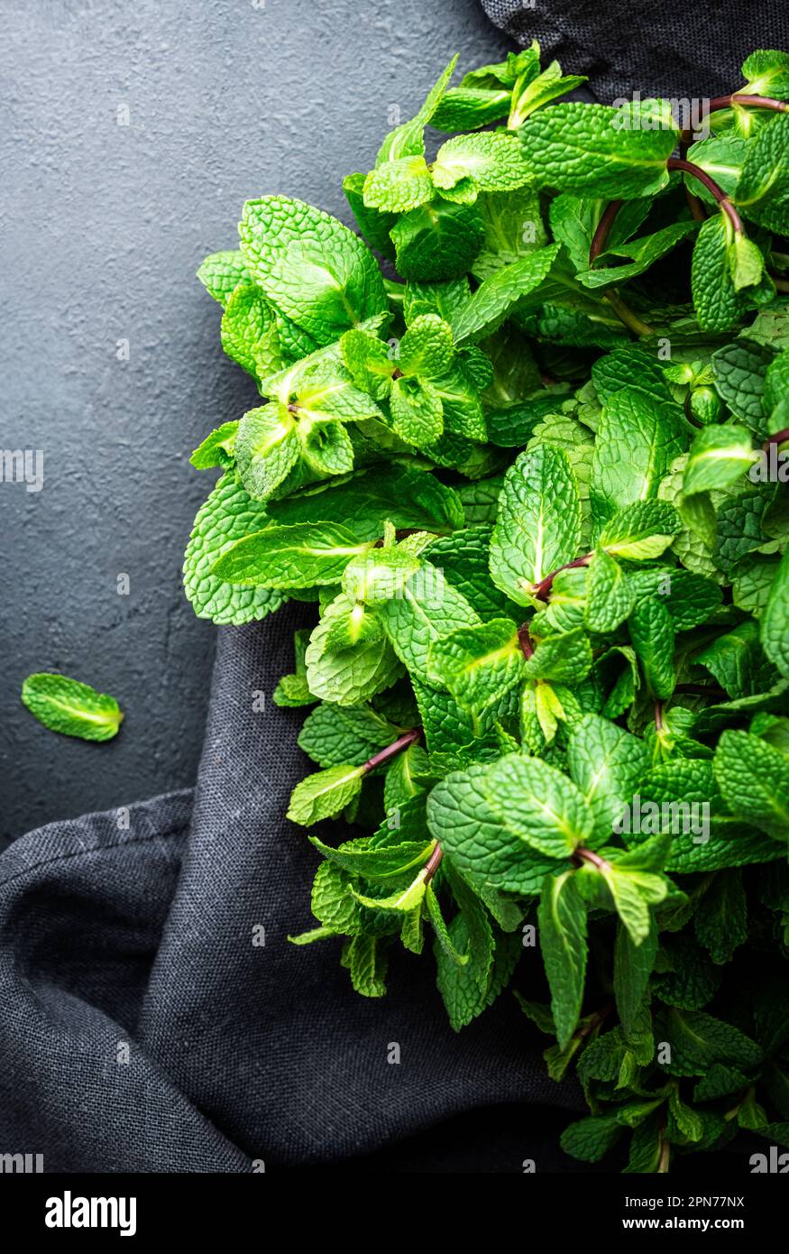 Fresh green mint on black stone table background. Medicinal and ...