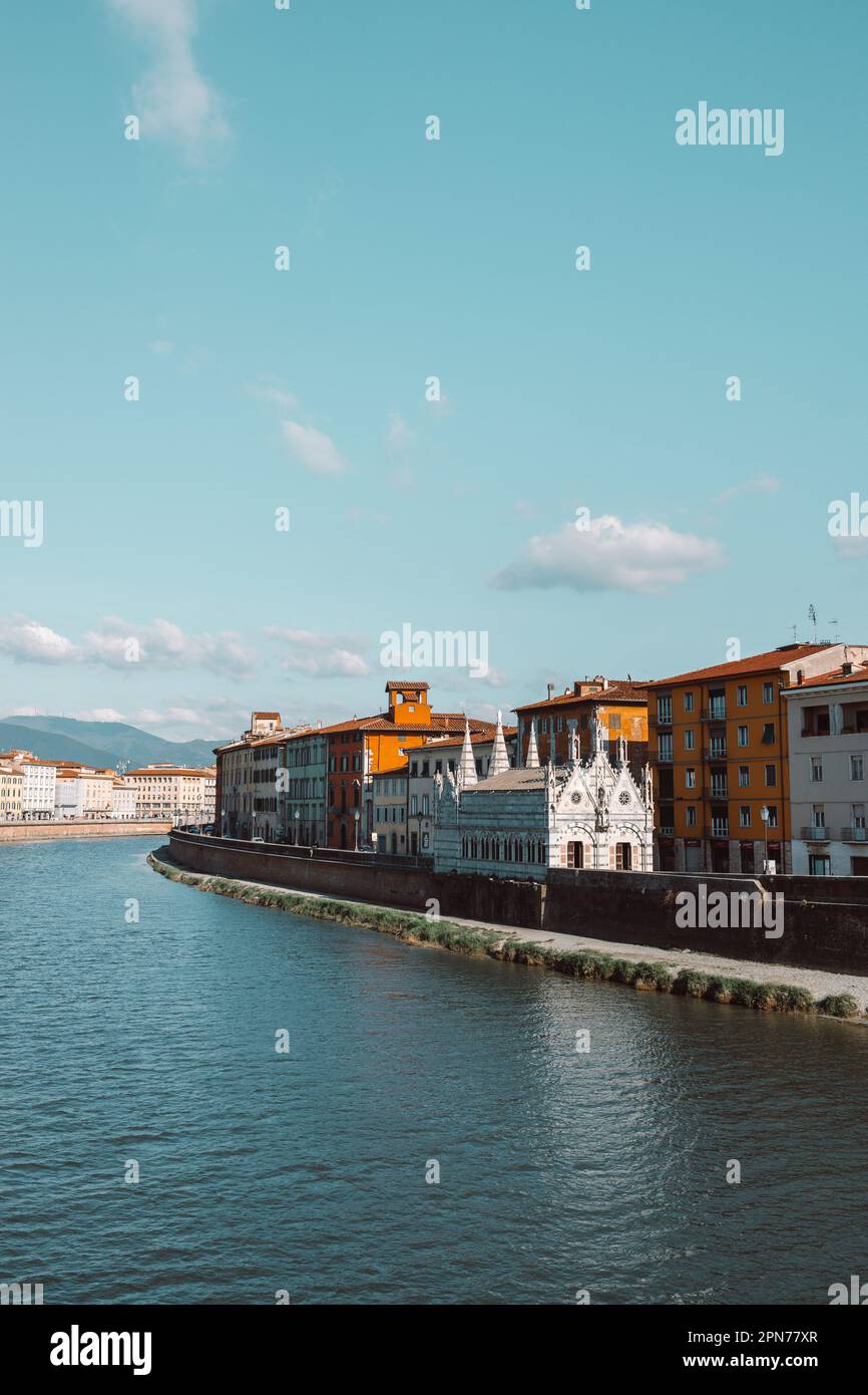 A beautiful view of buildings along the Arno river in Pisa, Italy. A ...