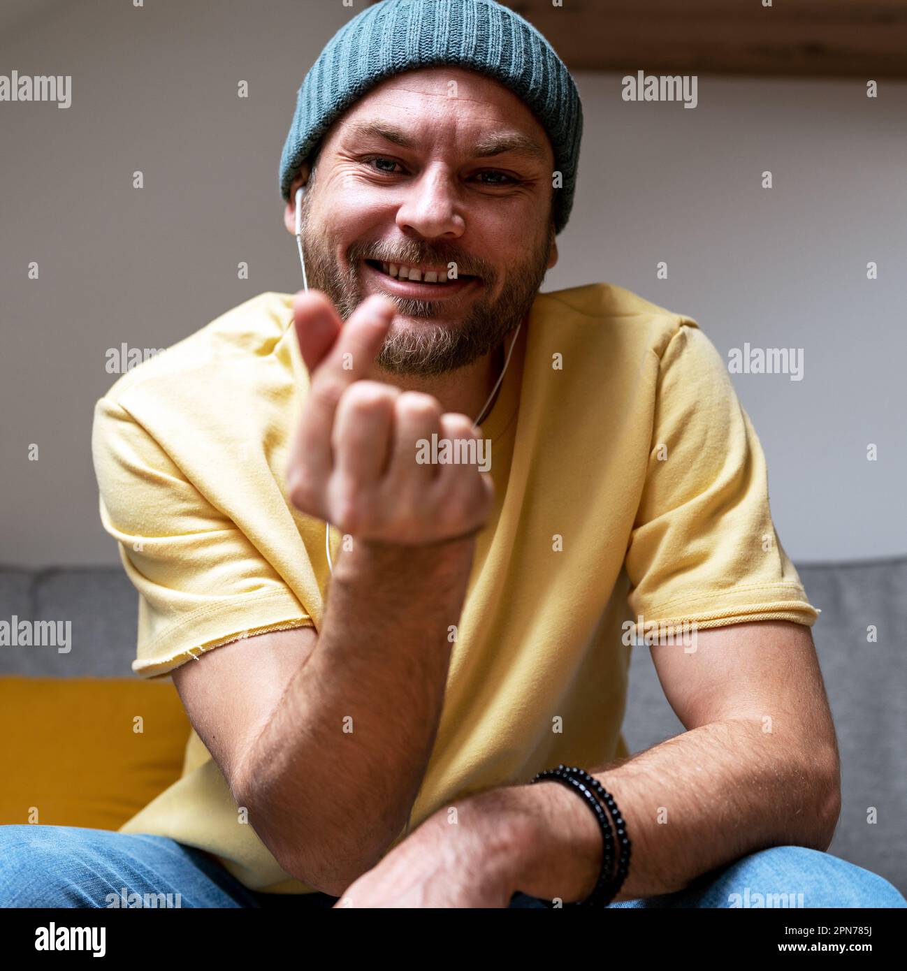 Man gestures the Finger Heart at camera and smiling while online ...