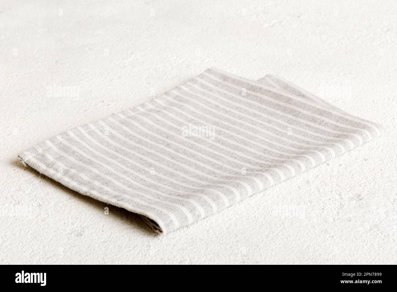 top view with gray kitchen napkin isolated on table background. Folded ...