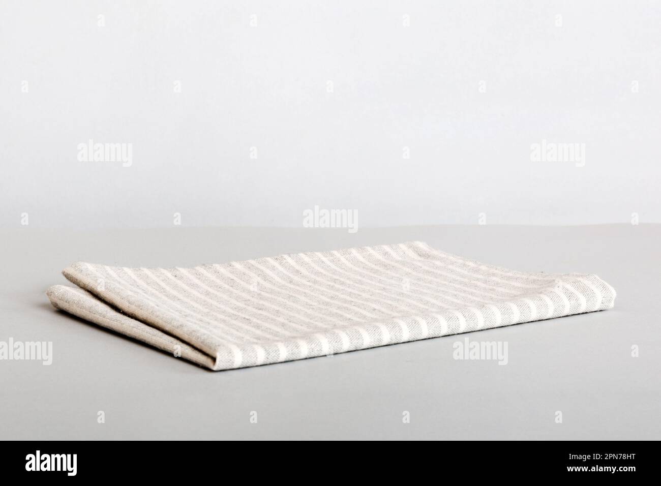 top view with gray kitchen napkin isolated on table background. Folded ...