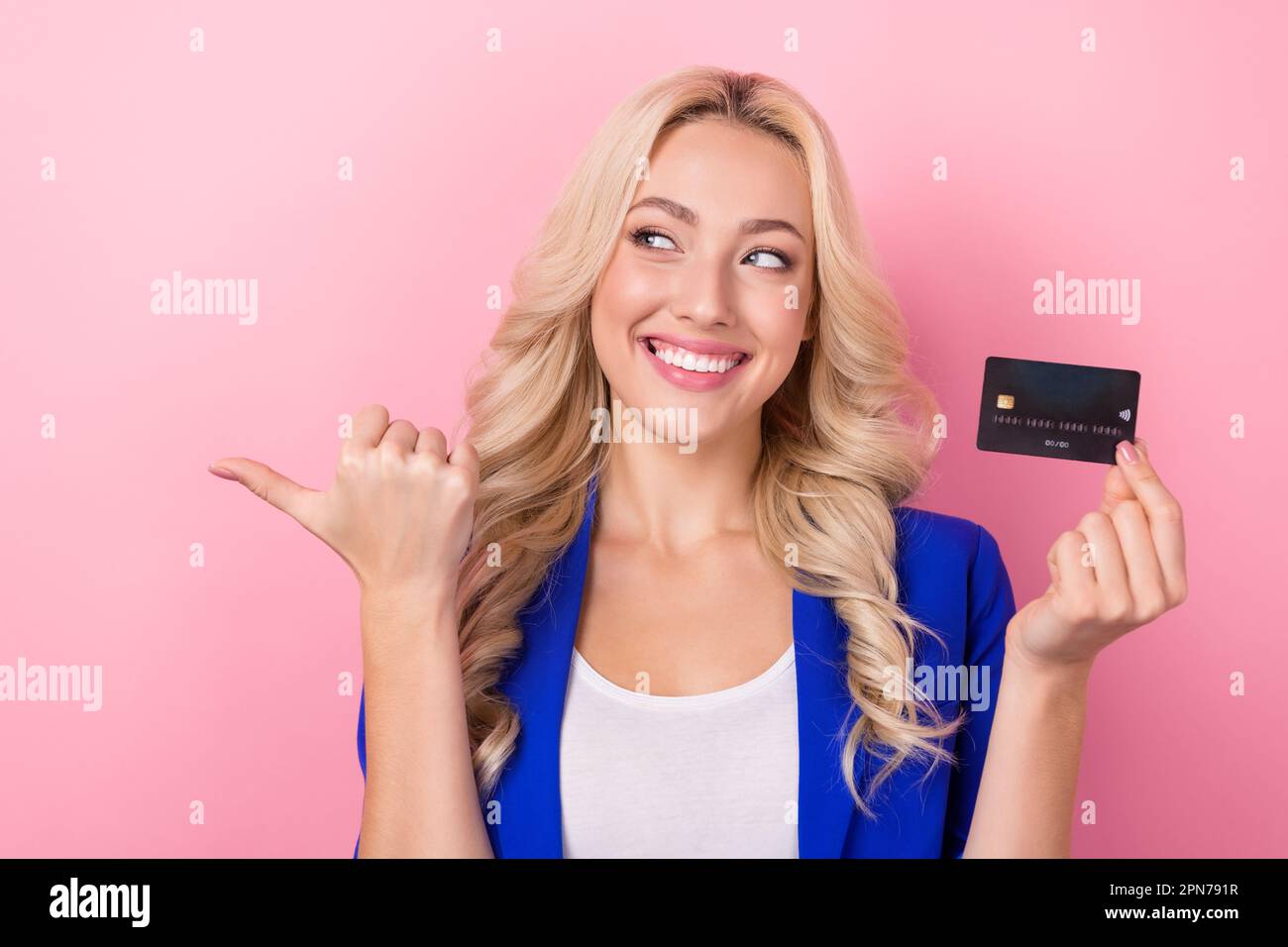 Portrait of charming cheerful person hand hold debit card look indicate ...