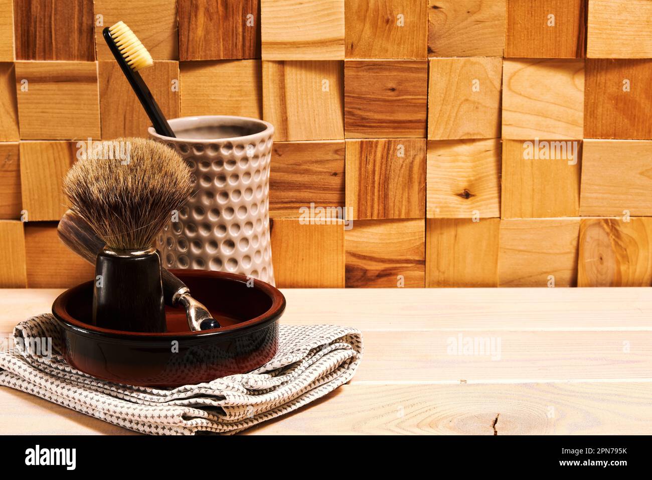 Wooden bathroom with men's shaving equipment, blade, brush and towel ...