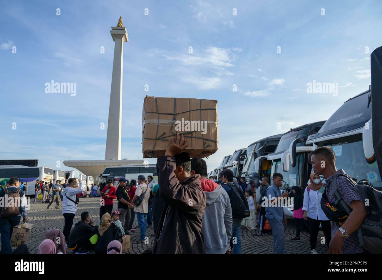 Jakarta, Indonesia. 17th Apr, 2023. People carry belongings to board free-of-charge buses to ...