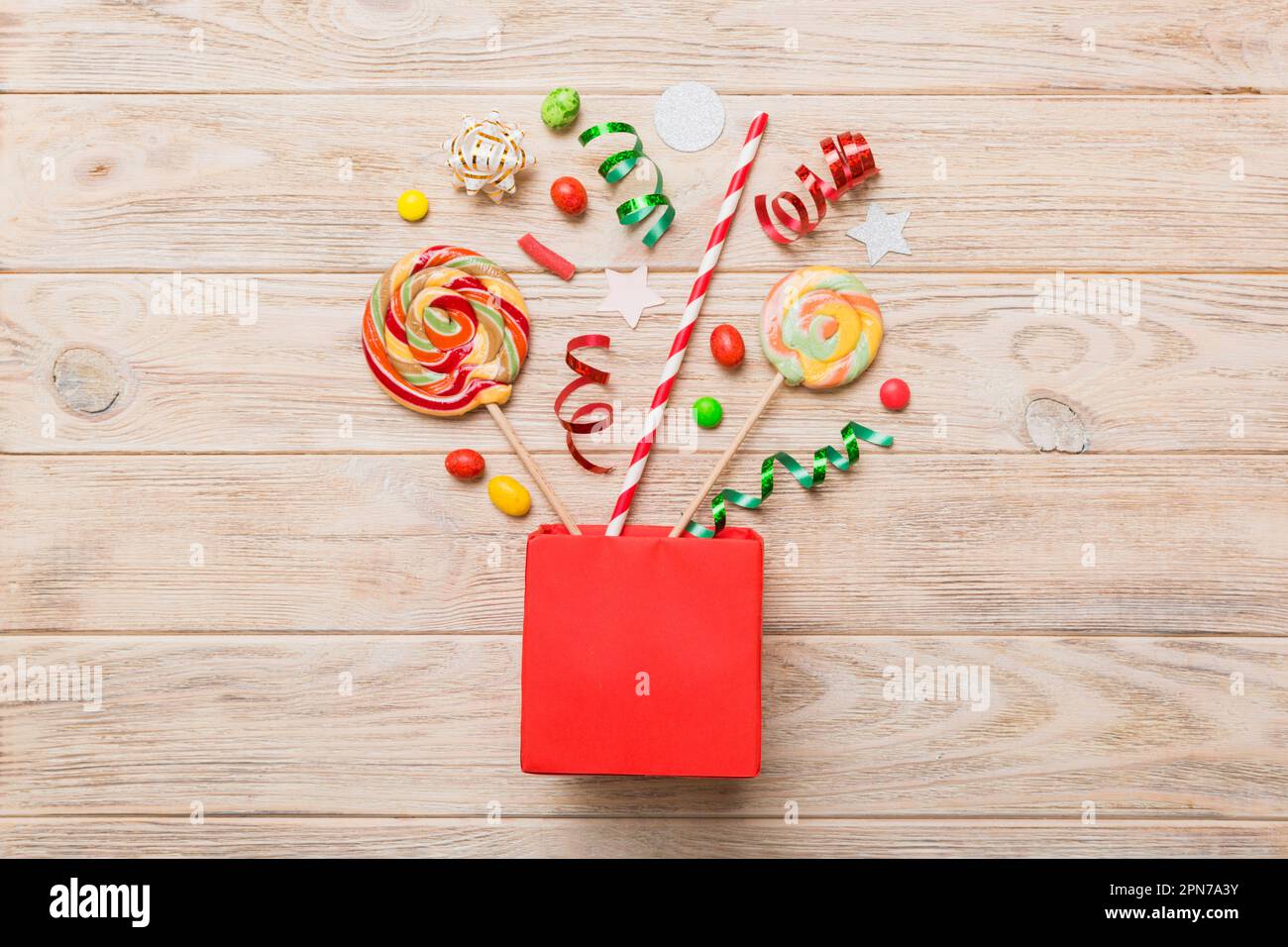 gift box in corner full of assorted traditional candies falling out on ...