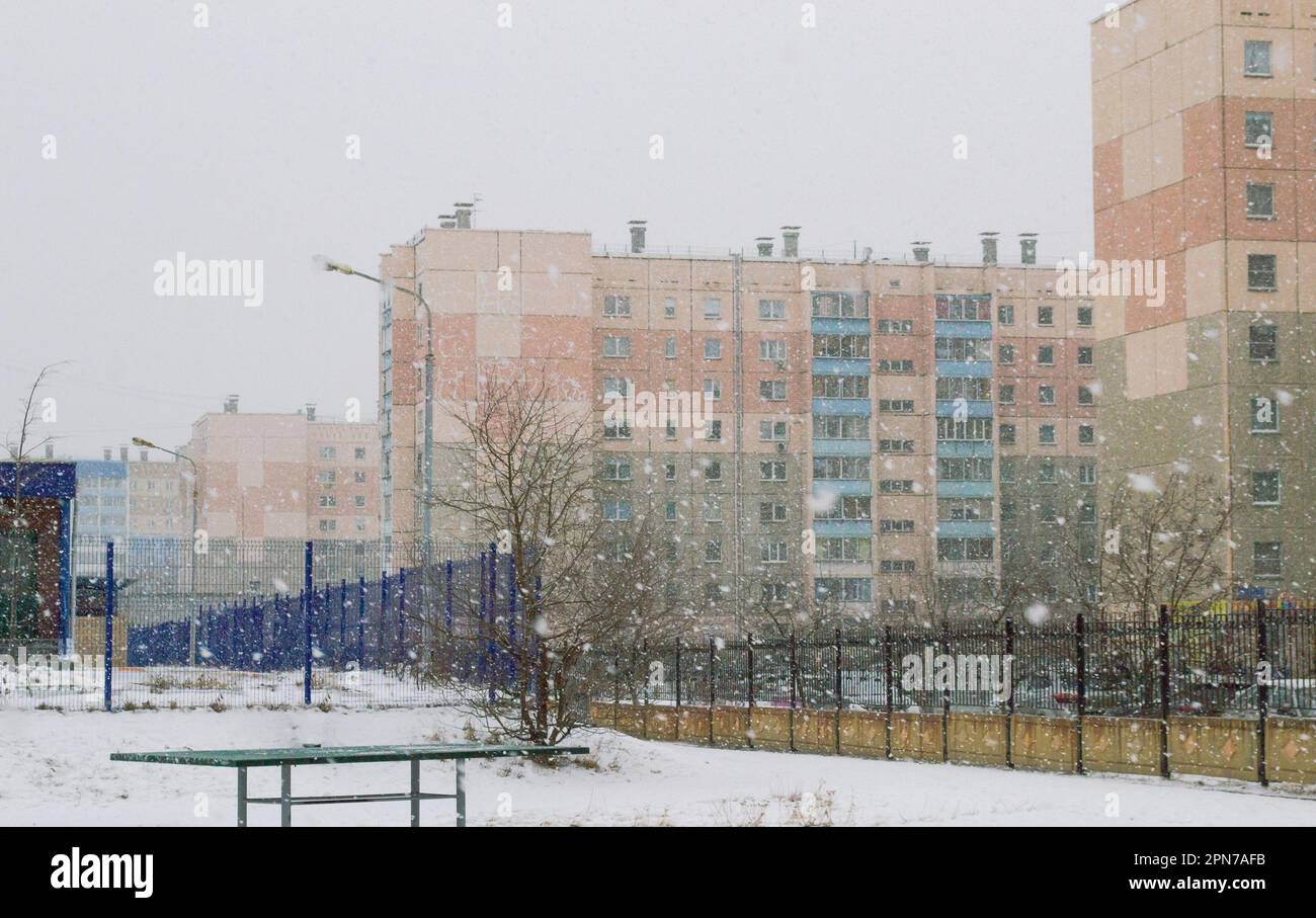 Heavy snowfall on the background of residential high-rise buildings in ...
