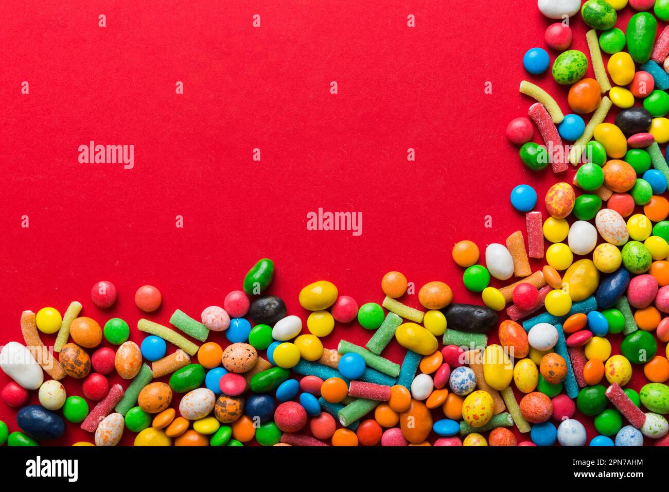 Mixed collection of colorful candy, on colored background. Flat lay ...