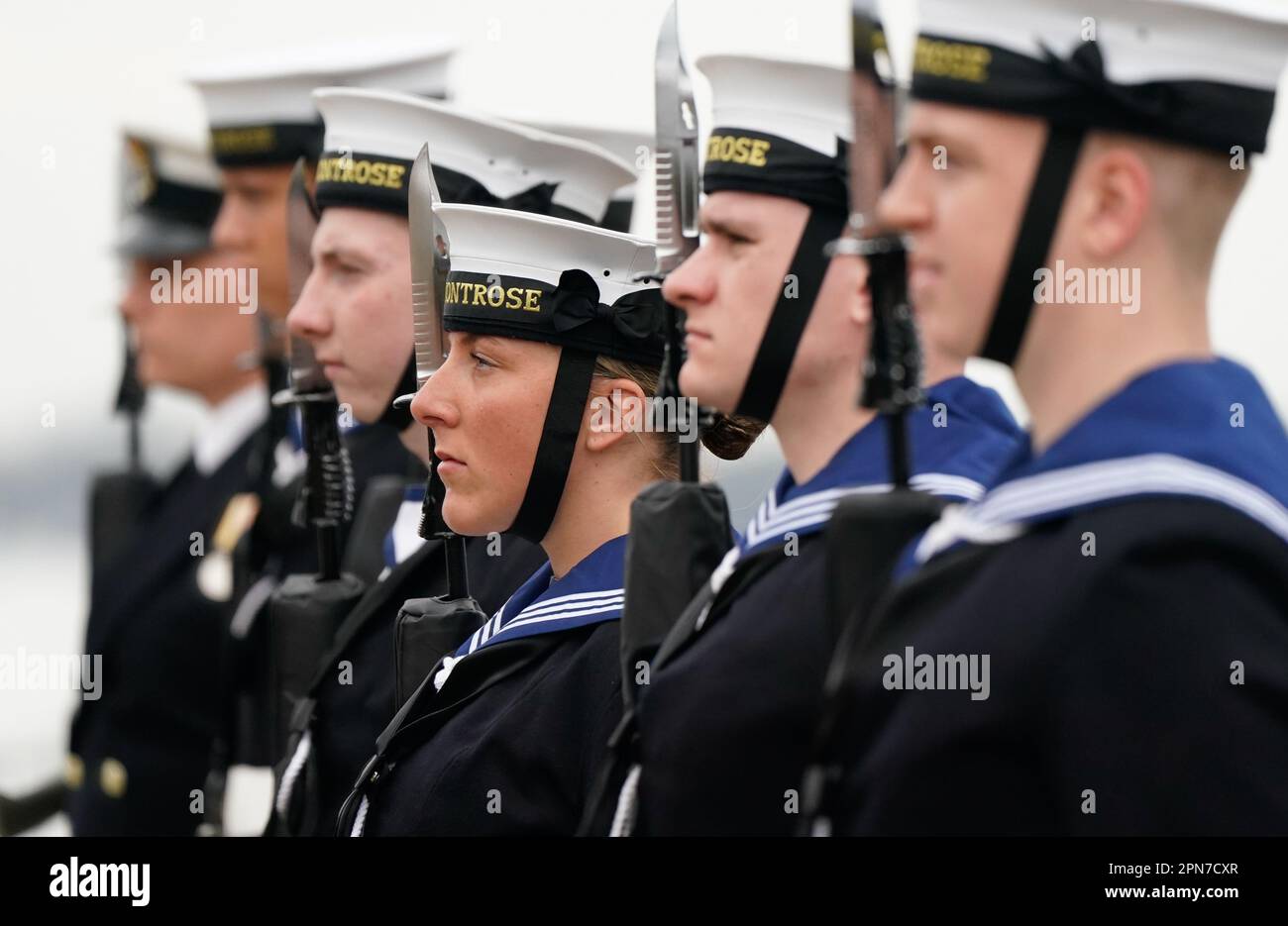 Member of the ship's company stand in position during the ...