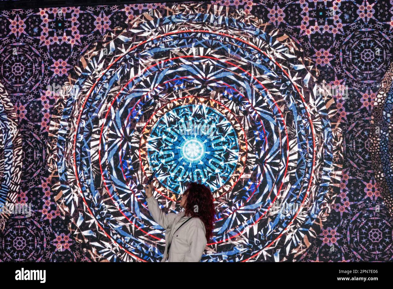 A person takes a photo of The Spaces In-Between installation by visual ...
