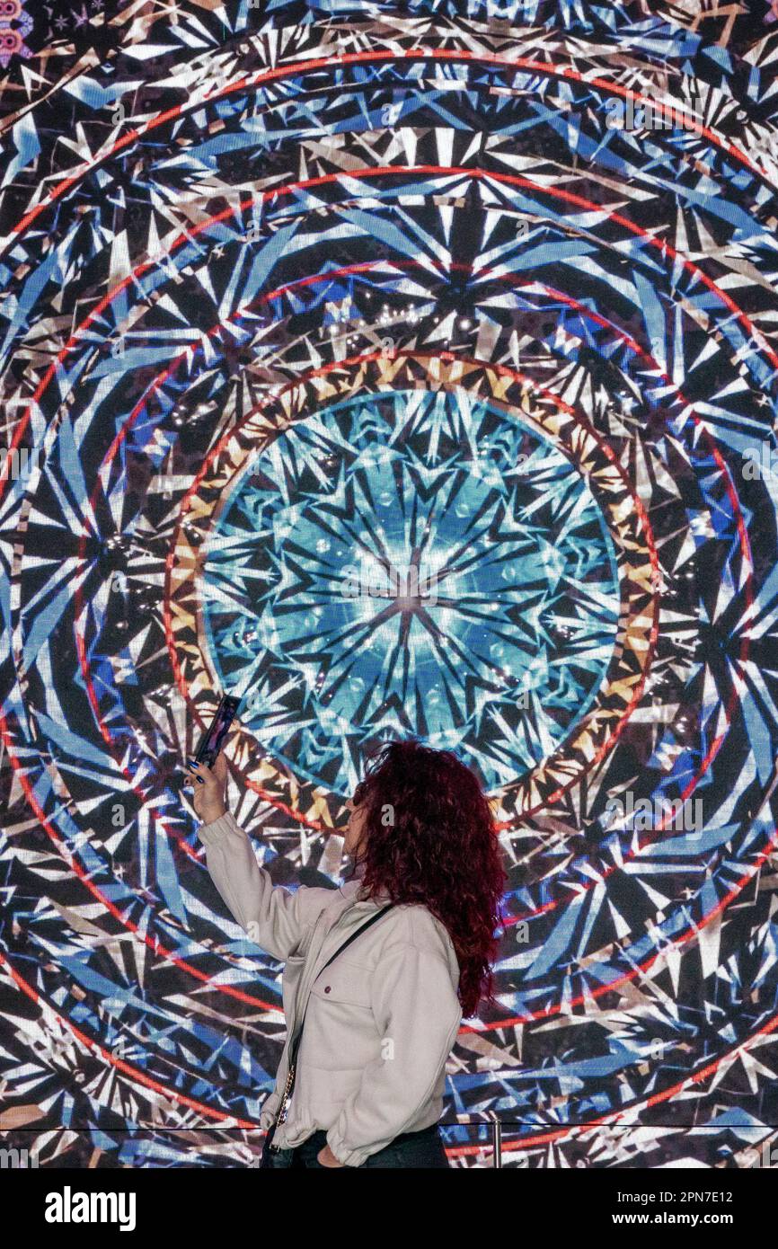 A person takes a photo of The Spaces In-Between installation by visual ...