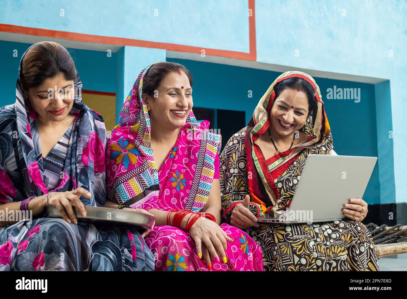 Group of traditional married indian women wearing sari do household ...