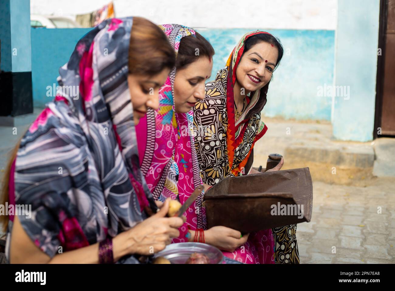 Group of traditional married indian women wearing sari do household ...