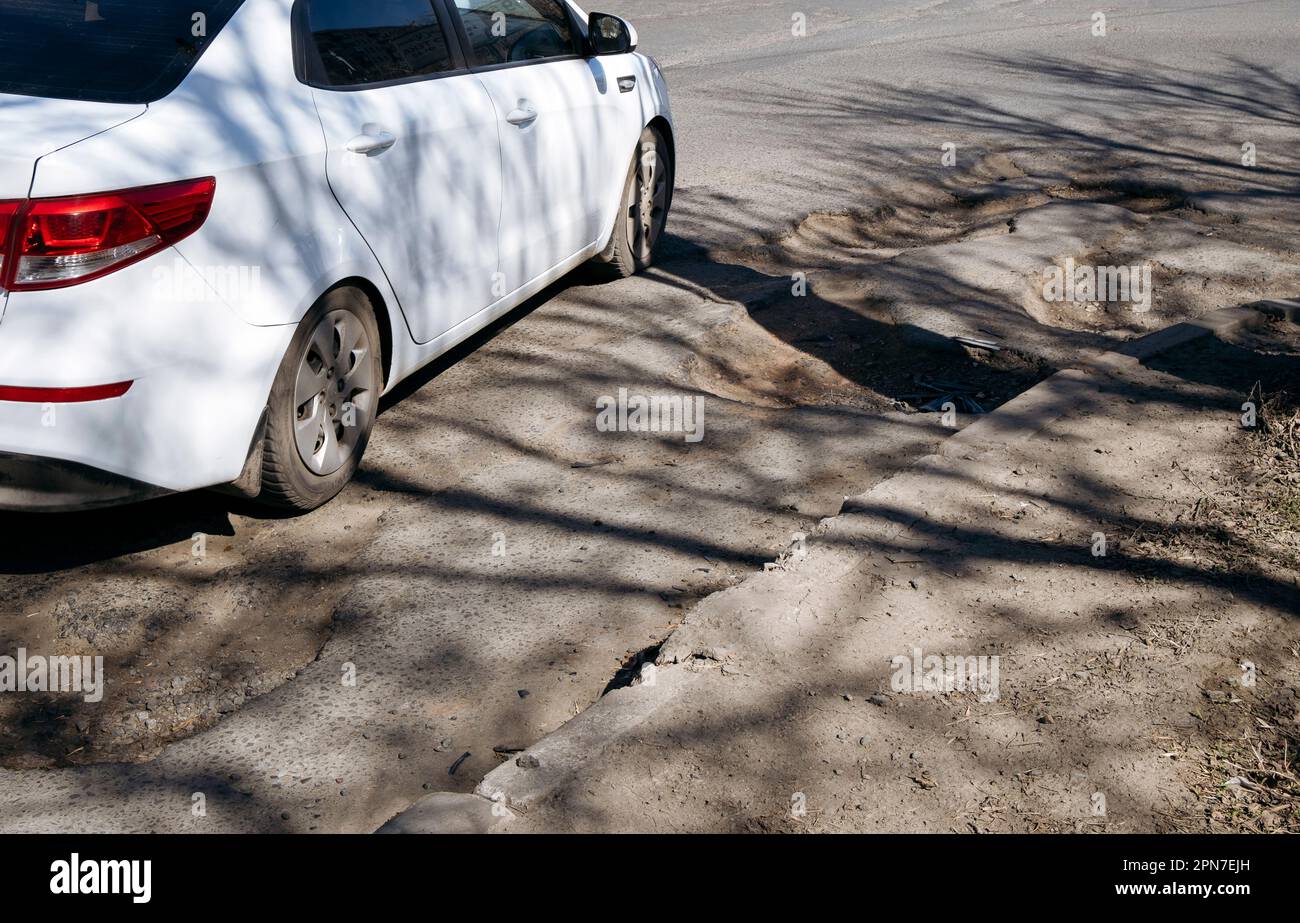 A highway with large pits and shadows from trees Stock Photo - Alamy