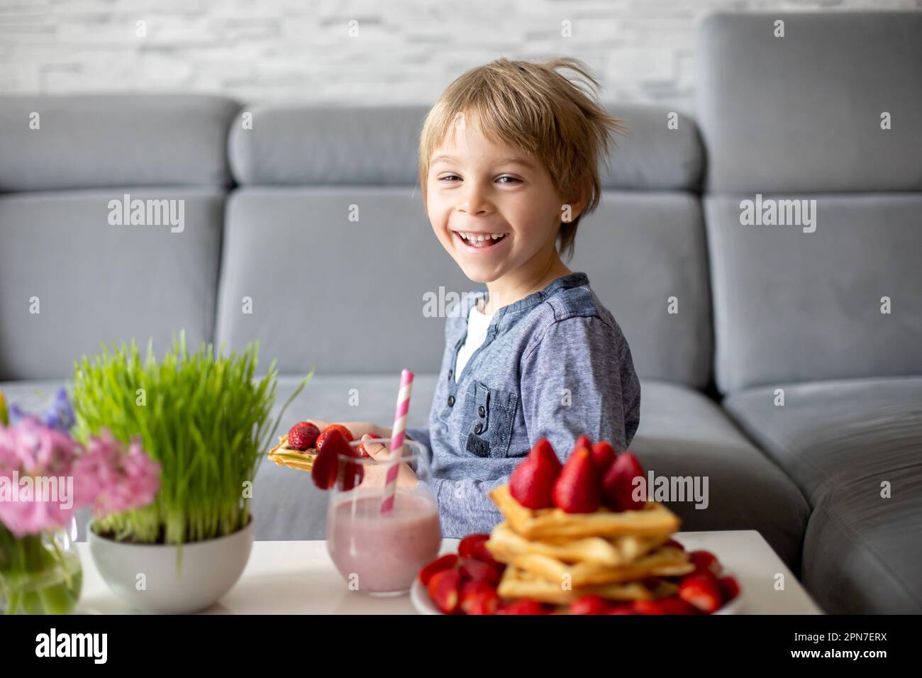 Sweet preschool child, boy, eating belgian waffle with strawberries and ...
